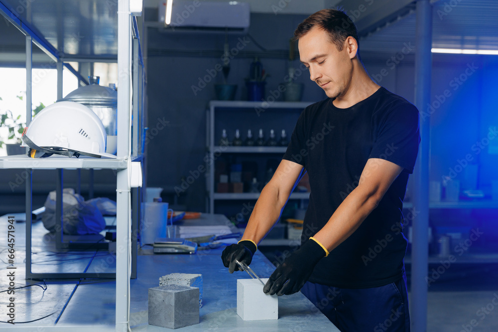 Engineer measures size and controls quality of concrete cube in ...