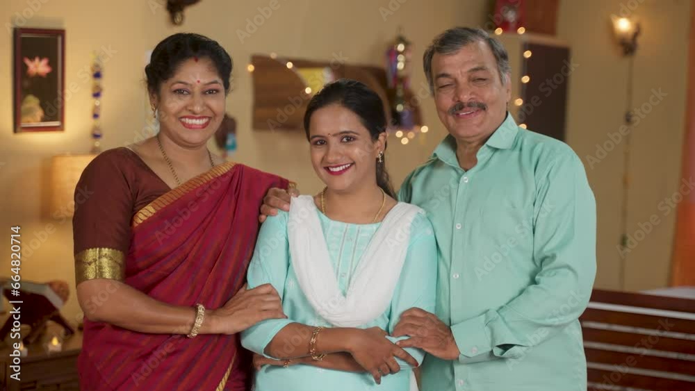 Happy smiling Indian middle class parents with daughter looking camera ...