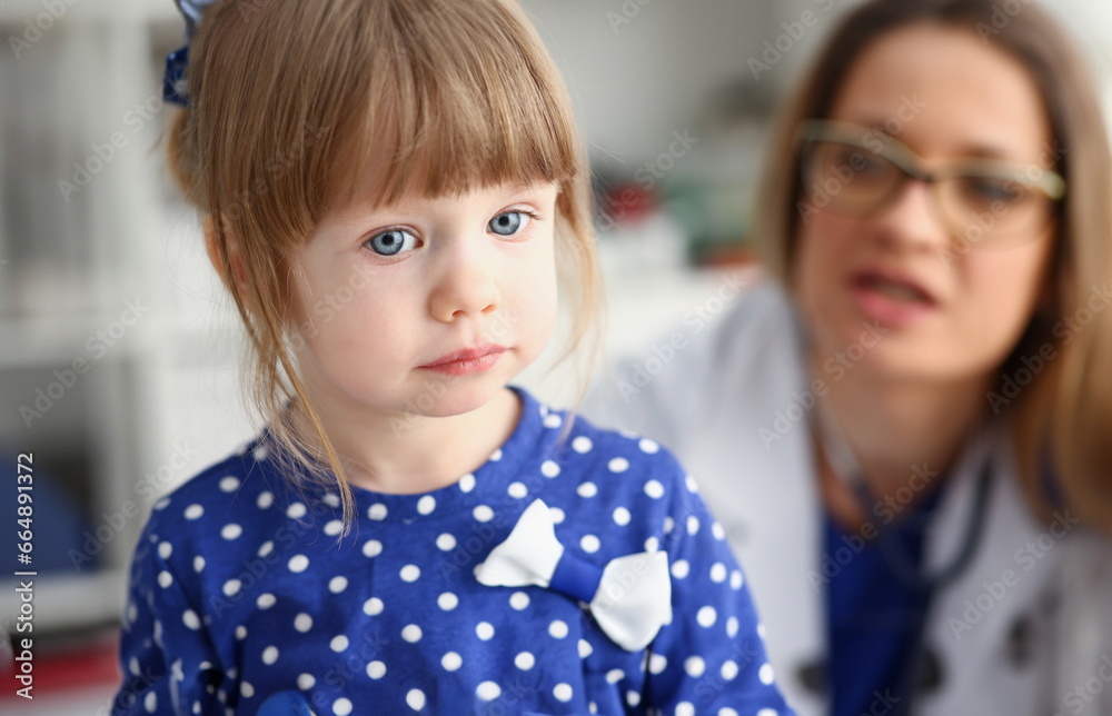 Little child with mother at pediatrician reception. Physical exam cute ...