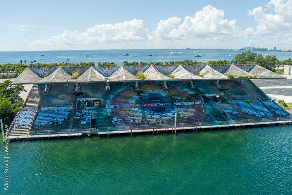 An aerial shot of Miami Marine Stadium with green ocean water, boats ...