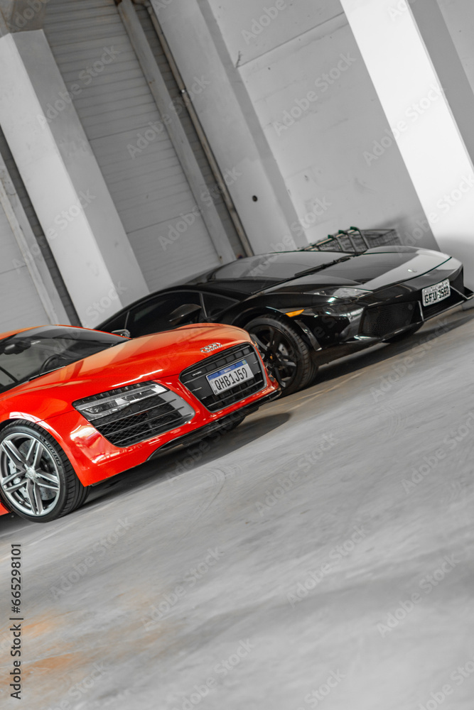 Red Audi R8 and black Lamborghini Gallardo parked side by side, Luxury ...