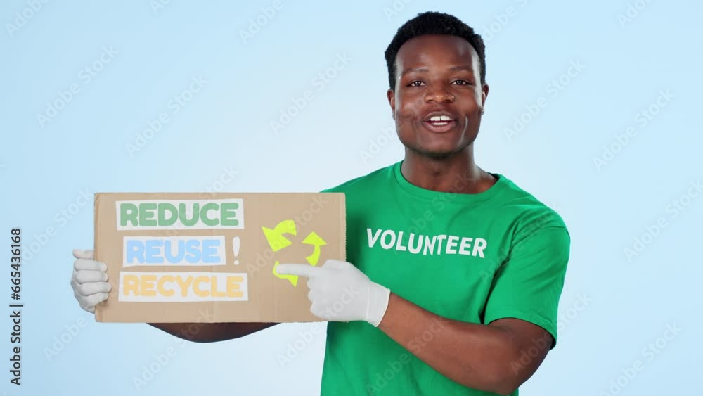 Reduce, reuse and recycle with a black man volunteer pointing to a sign ...