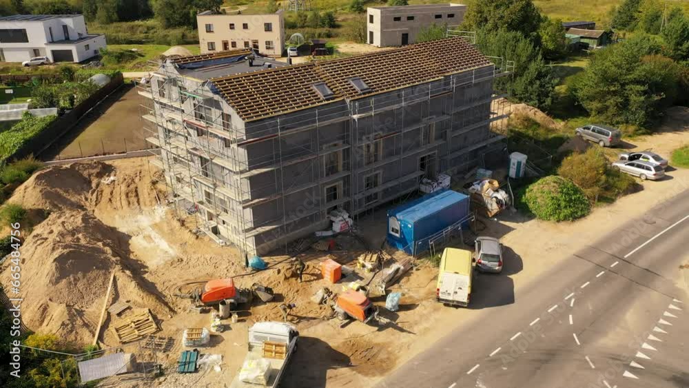 Drone footage of new residential house construction site, scaffolding ...