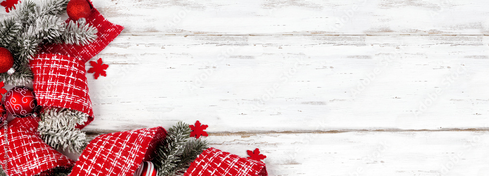 Christmas red and white corner border of ornaments, branches and ribbon ...