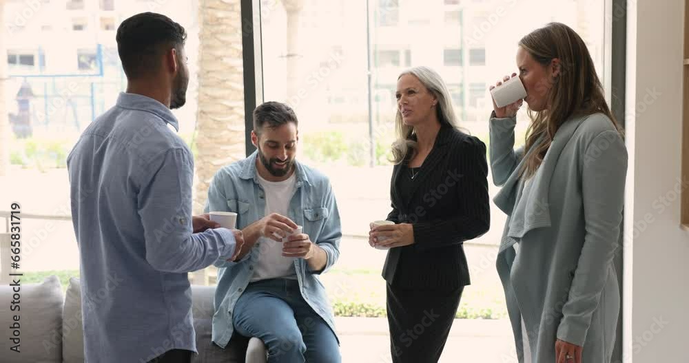 Group of young and mature multiethnic colleagues met in office hall ...