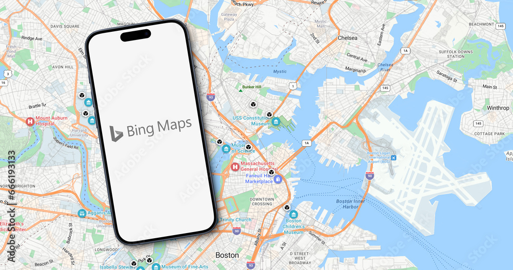 Bing Maps logo with lettering is displayed on a smartphone lying on a map view of Bing Maps ...