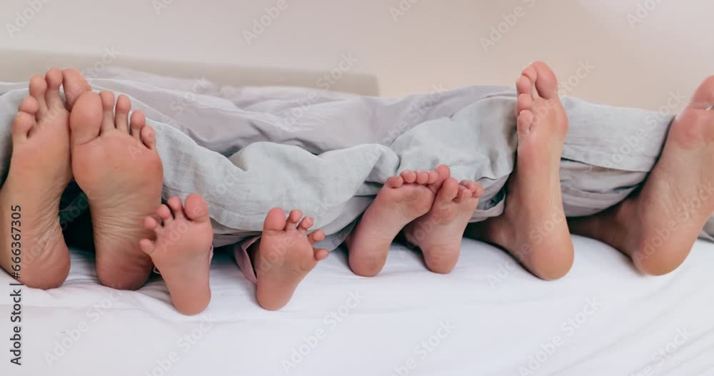 Sleep, feet and family in a bed relax, nap or bonding in their home on ...