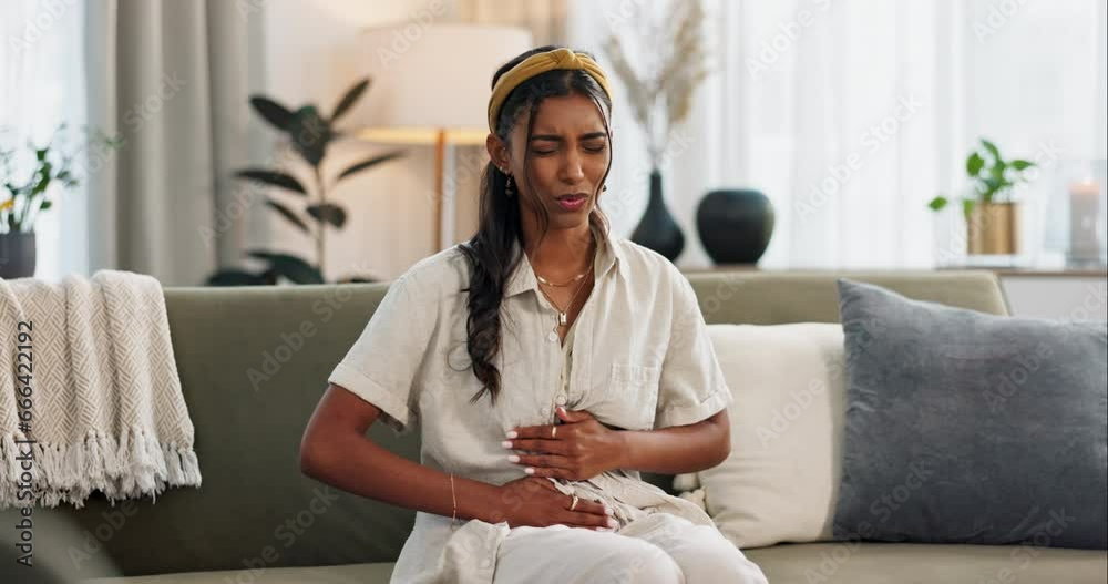 Woman, upset and stomach pain for digestion in home with discomfort on ...