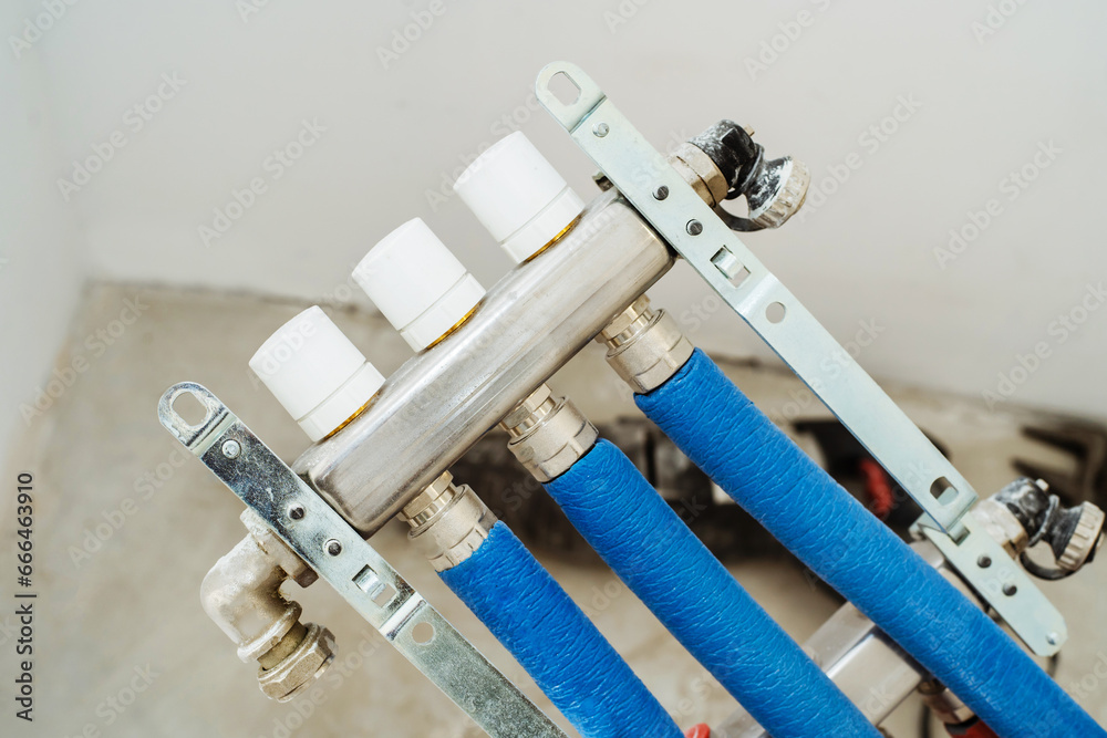 Valves and pipes of the heating distribution system in an apartment or ...