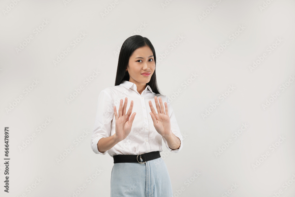 The photo of a young Asian woman making a rejection pose, wearing a ...