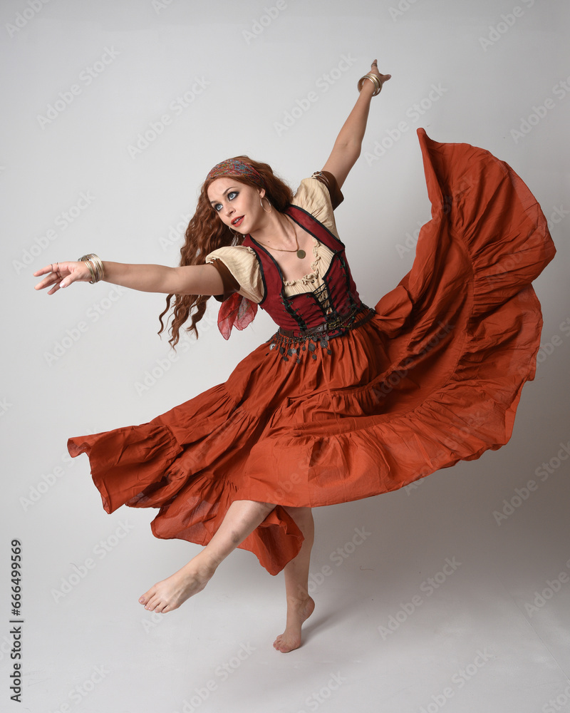 Full length portrait of beautiful red haired woman wearing a medieval ...