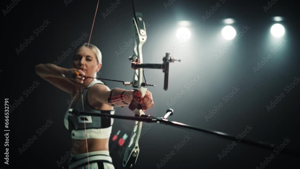 Pro Female Athlete Doing Archery, Aiming and Shooting at a Target ...