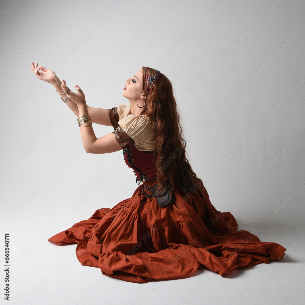 Full length portrait of beautiful red haired woman wearing a medieval ...