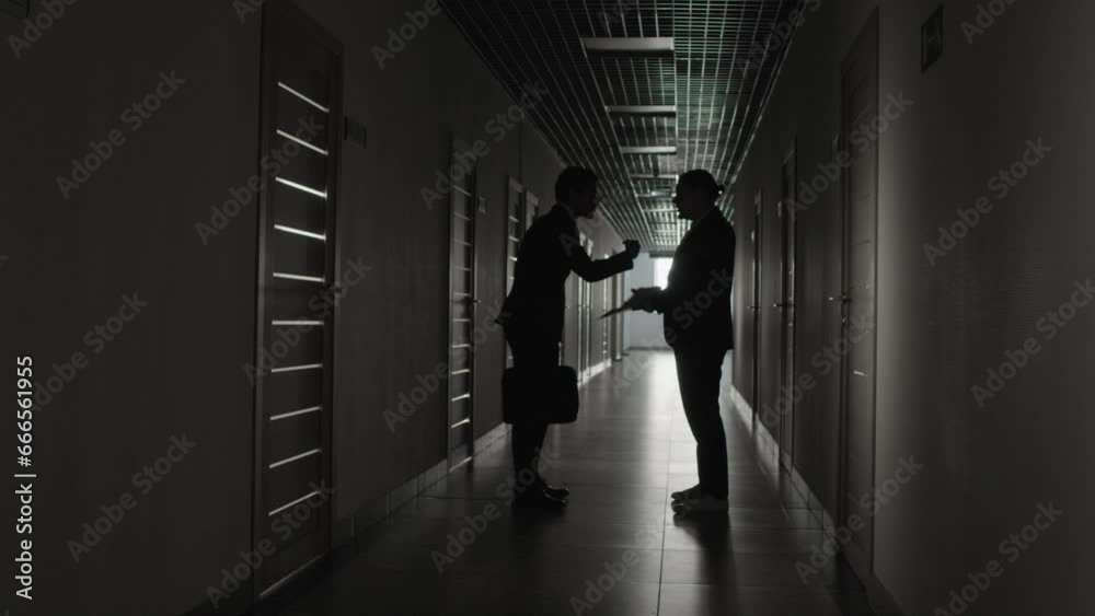 Full shot of two male figures in formal suits arguing while standing in ...
