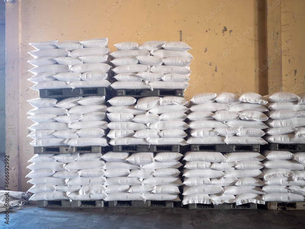 Bags of milled rice stacked on pallets and store inside warehouse ...