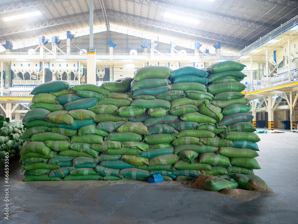 Stack of rice bran bag in the rice milling plant. Agricultural product ...