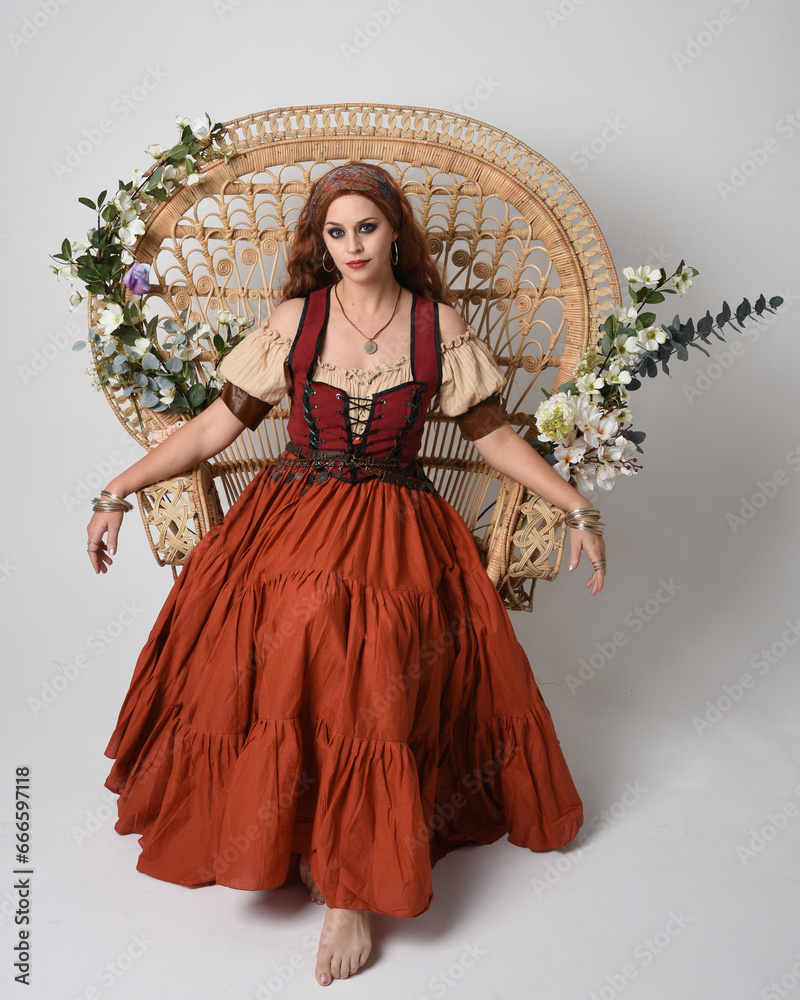 Full length portrait of beautiful red haired woman wearing a medieval ...