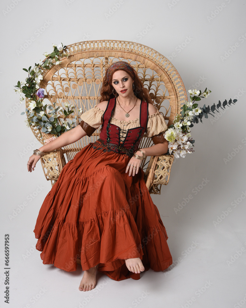 Full length portrait of beautiful red haired woman wearing a medieval ...
