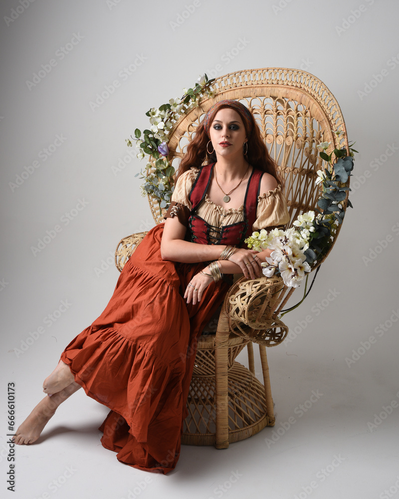 Full length portrait of beautiful red haired woman wearing a medieval ...