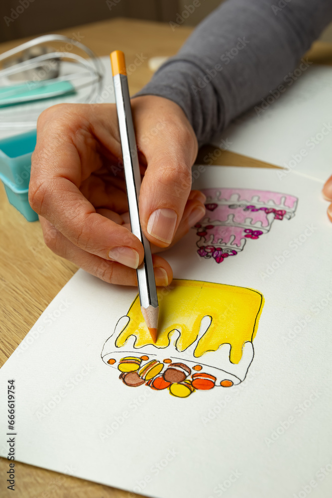 The pastry chef develops a cake design by drawing on paper. Creation of ...