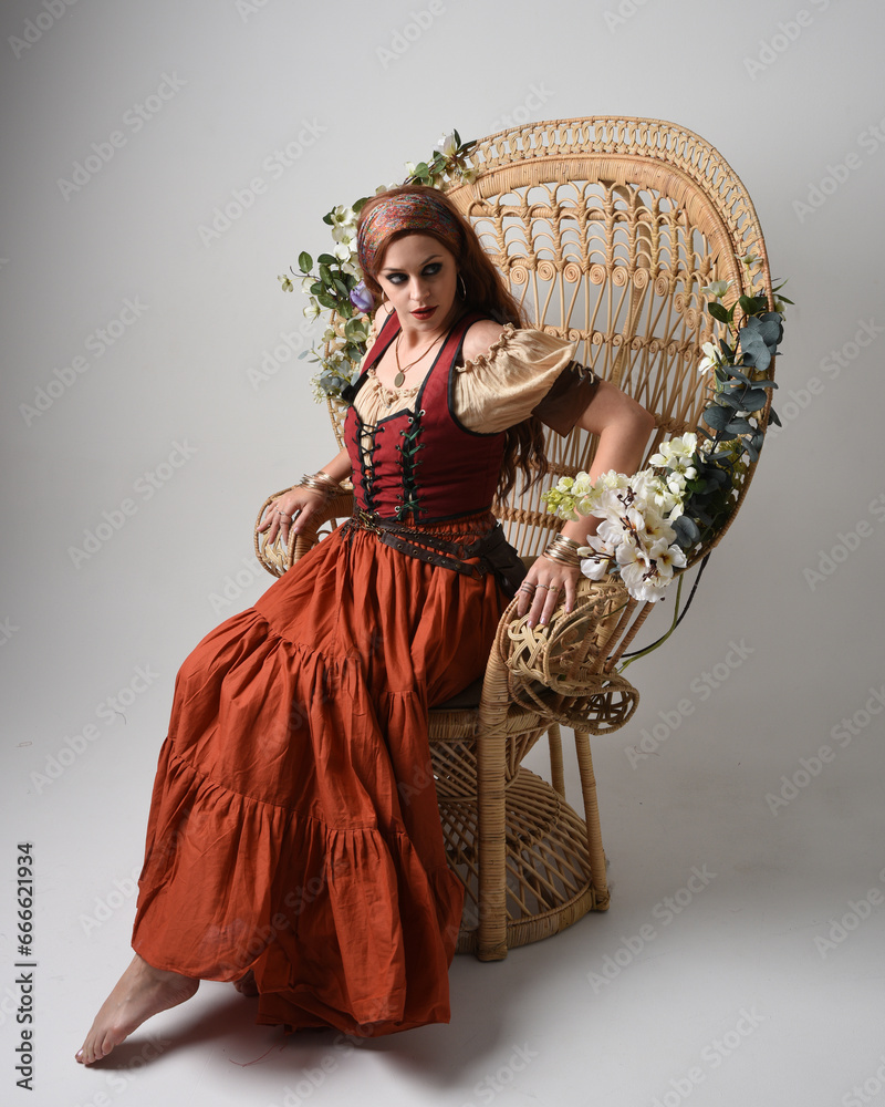 Full length portrait of beautiful red haired woman wearing a medieval ...