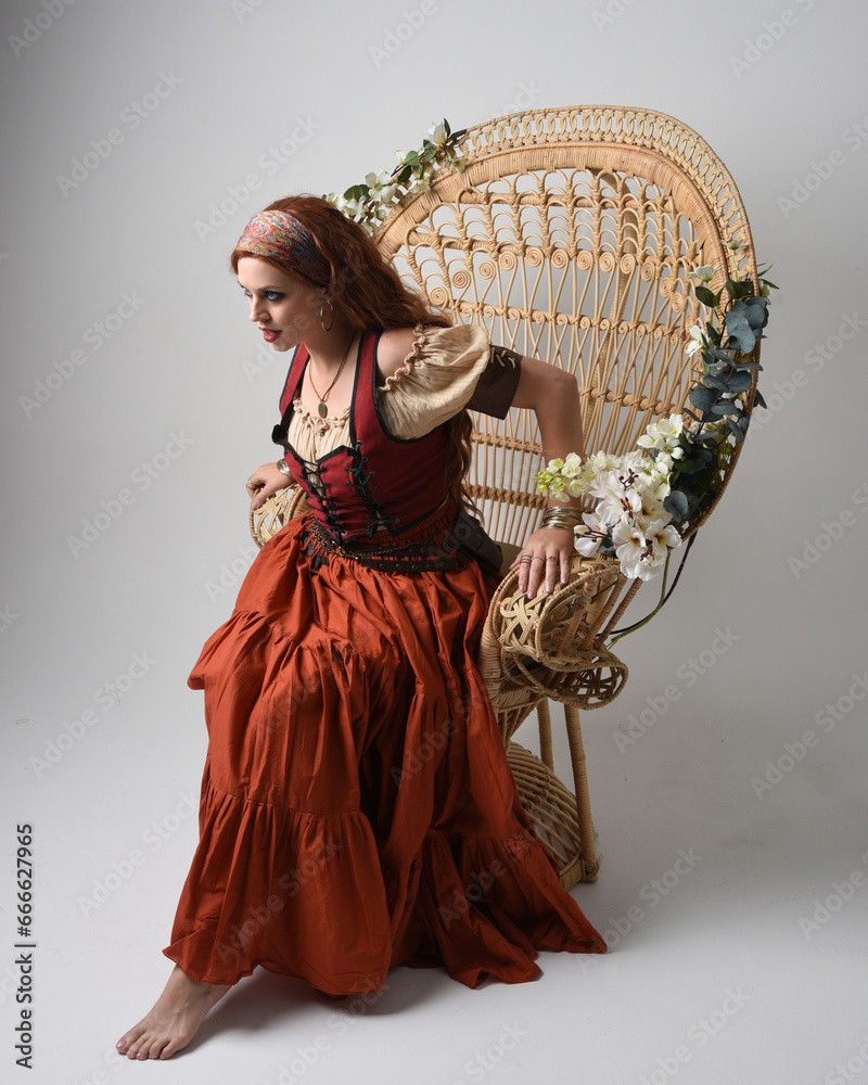 Full length portrait of beautiful red haired woman wearing a medieval ...