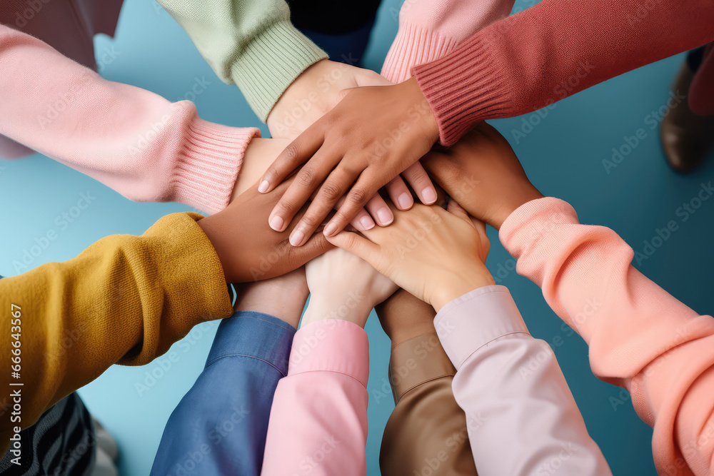 Collaboration and Teamwork: A group of diverse people huddled together ...