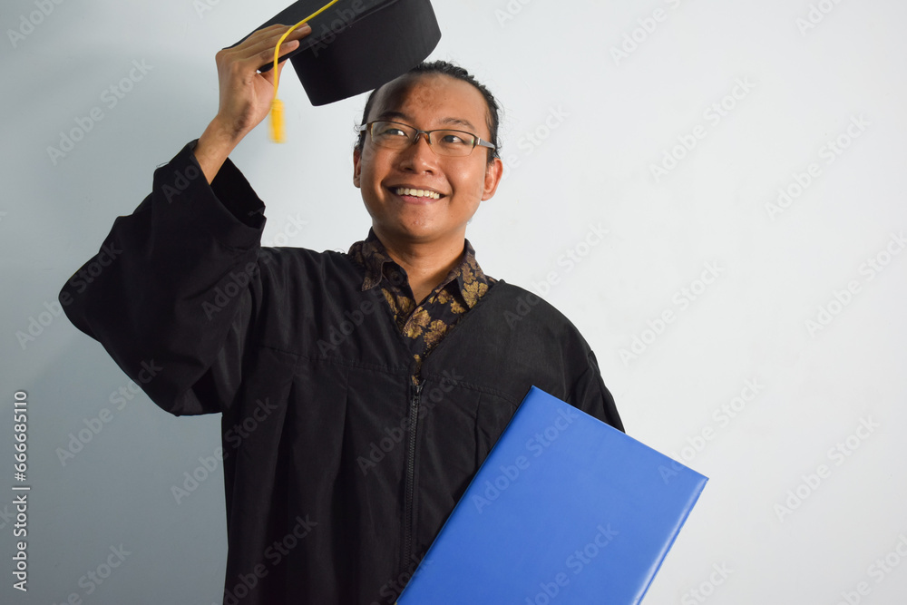 Expressive of Adult indonesia male wear graduation robe, hat and ...