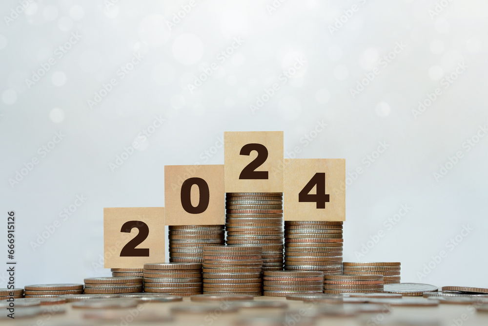 Financial 2024 concept.2024 wooden cubes on stack of coins. financial ...