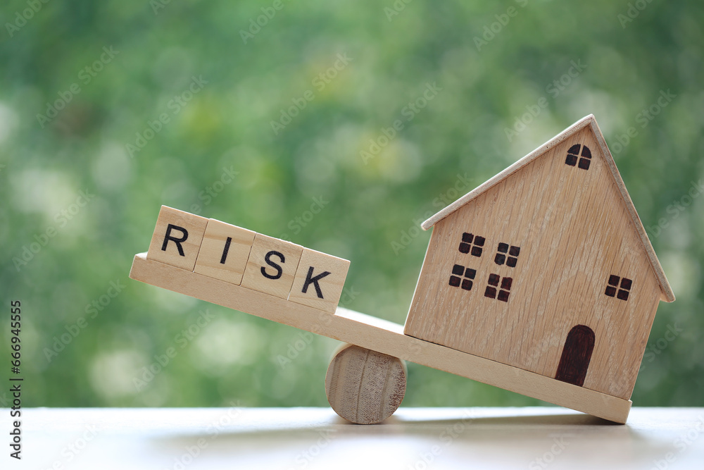 Insurance, Model house and Wording risk on wood block on natural green ...