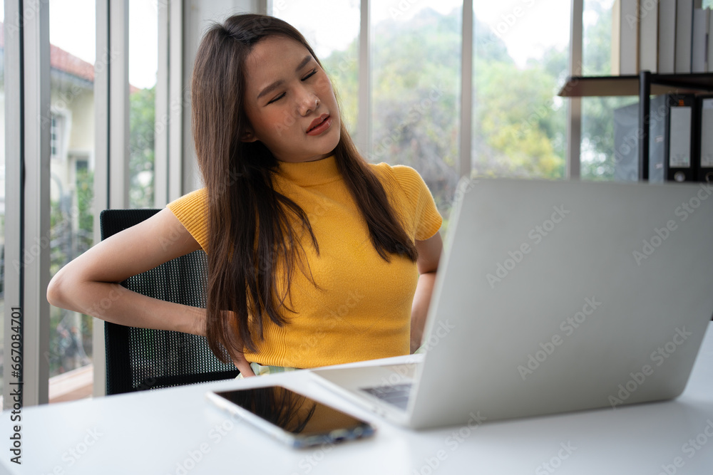 Beautiful young Asian businesswoman back body pain during work long ...