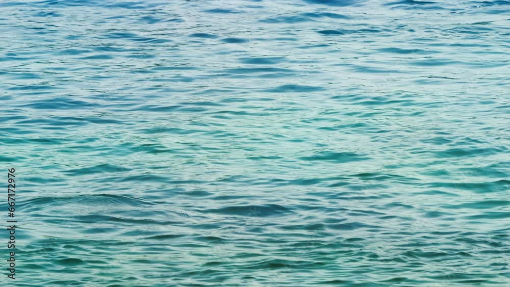 rippled water surface of blue flowing water texture, empty slow motion ...