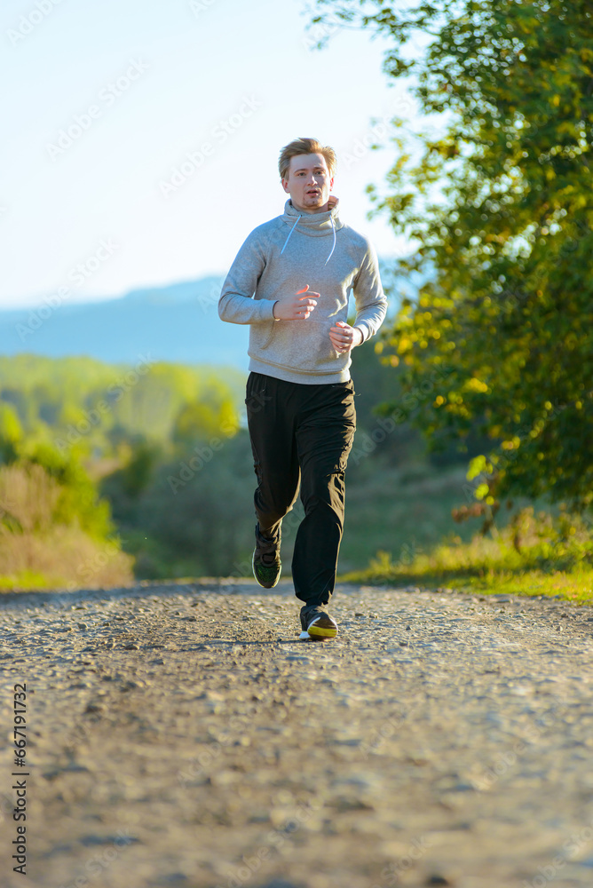 Running man jogging in rural nature at beautiful summer day. Sport ...