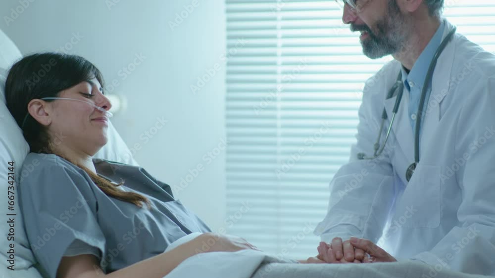 Vidéo Stock Careful doctor in medical coat holding hands of female ...