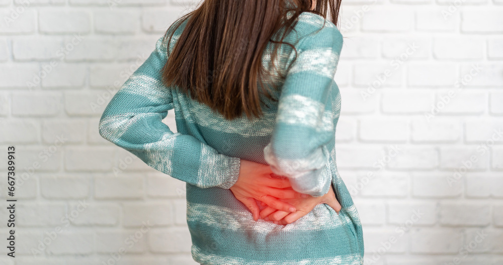 Woman unhappy holding back pain with suffering from backache, Lower ...