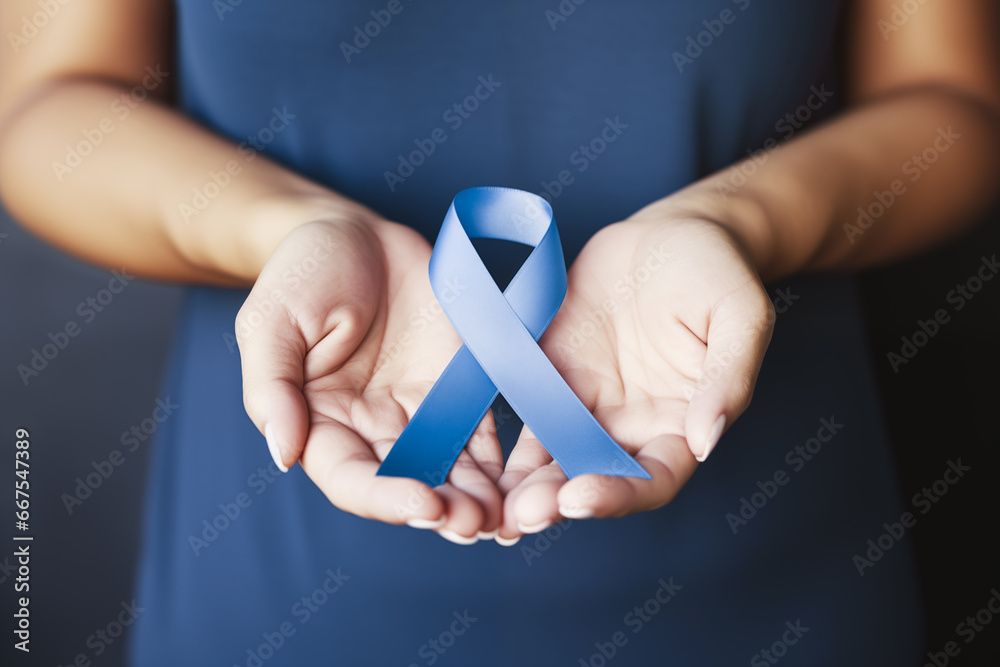 Periwinkle blue ribbon awareness with color bow on woman's hand for ...