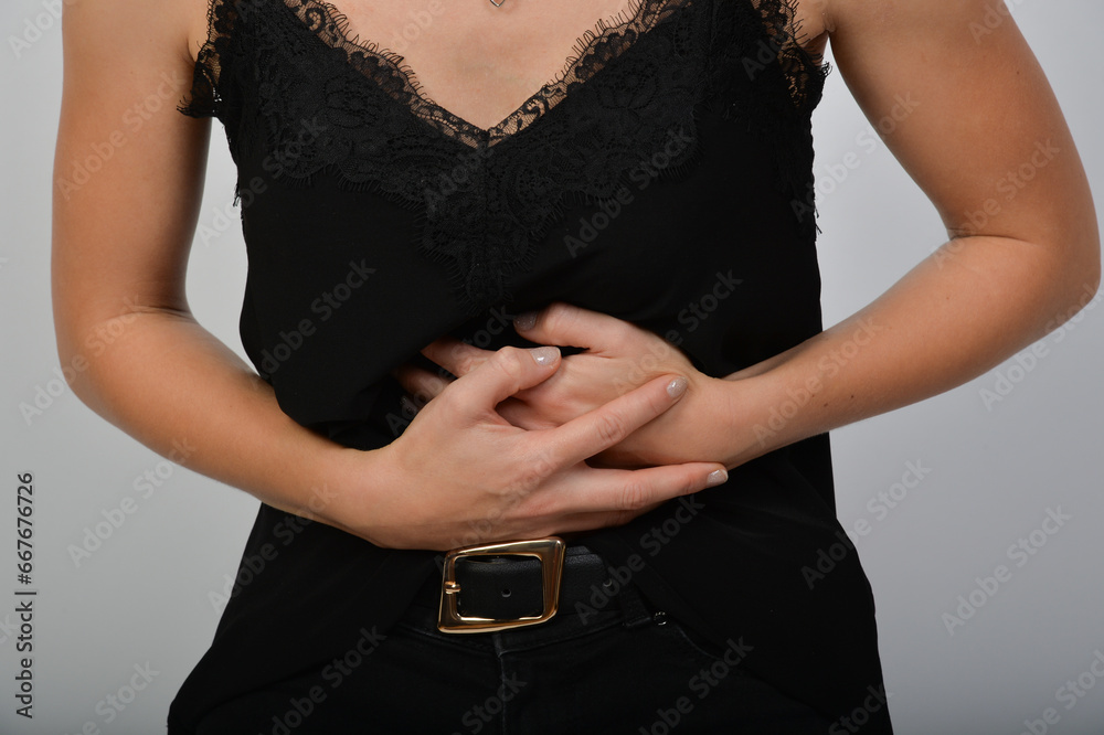 frau hält sich hände an den bauch wegen krampf krämpfen bauchschmerzen ...