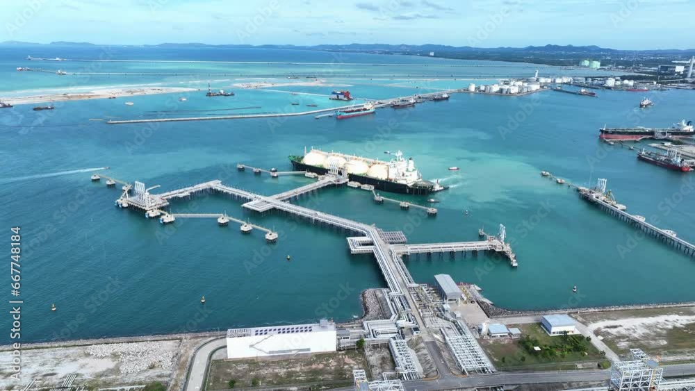 LNG (Liquefied natural gas) tanker anchored in Gas terminal gas tanks ...