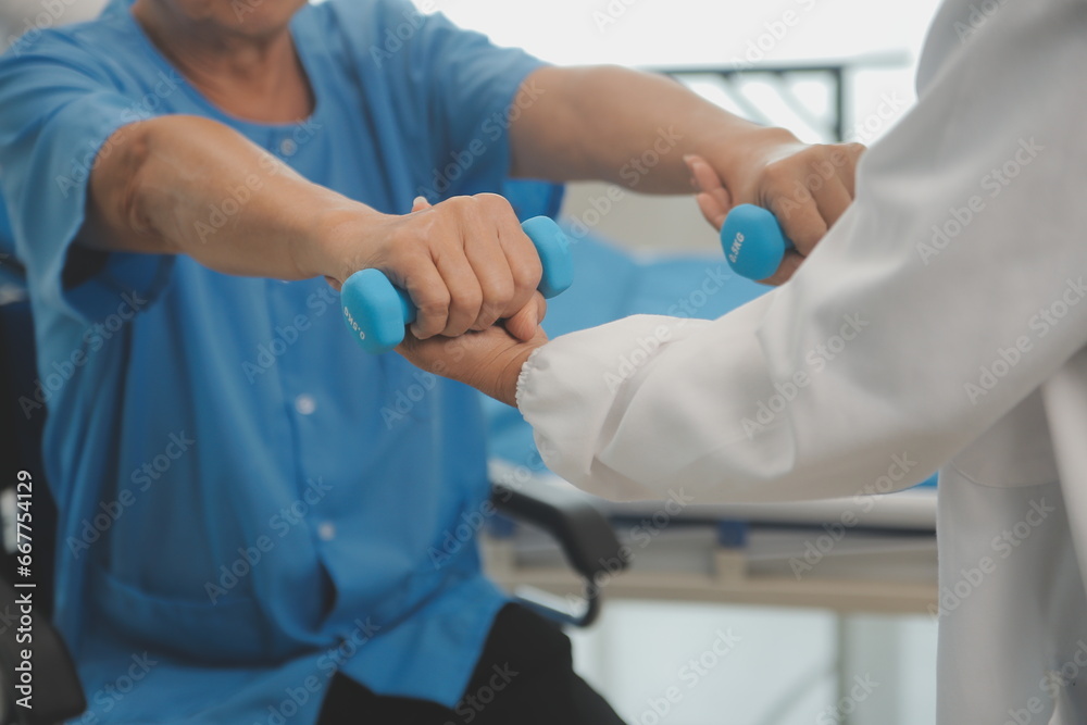 Asian older aged man doing physiotherapist with support from nurse ...