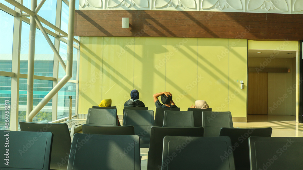 Waiting hall at Yogyakarta International Airport. People sitting ...