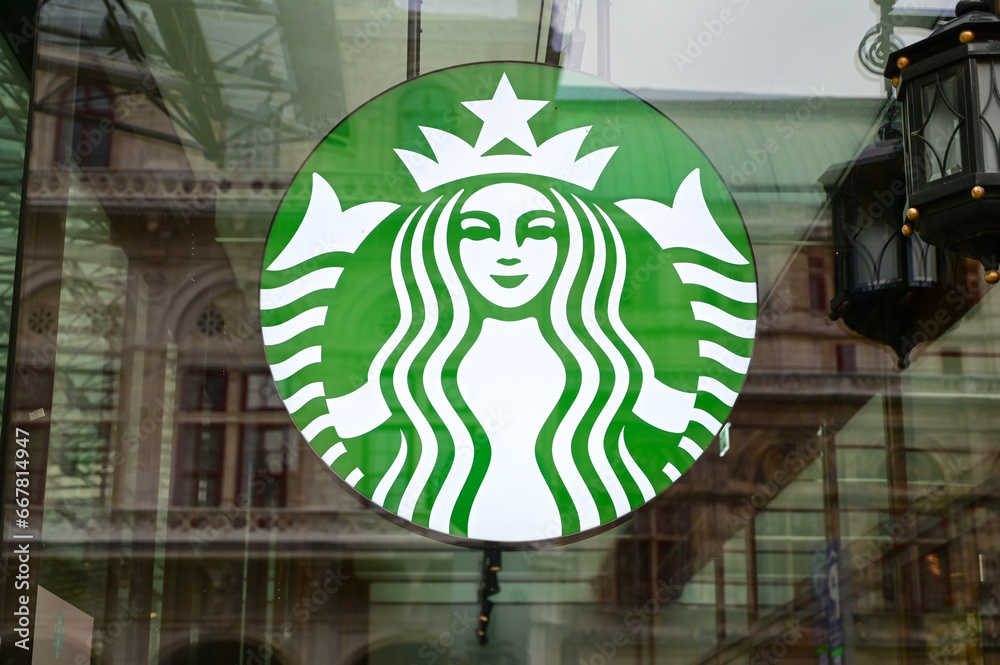 Starbucks sign in front of cafe. Logo of Starbucks. American chain of ...