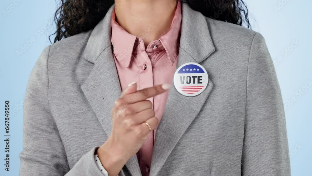 Woman in studio with campaign to vote, badge and hand showing choice ...