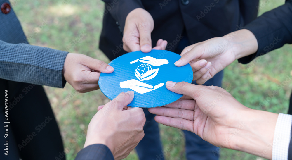 Business people holding ECO friendly idea symbol together as group of ...
