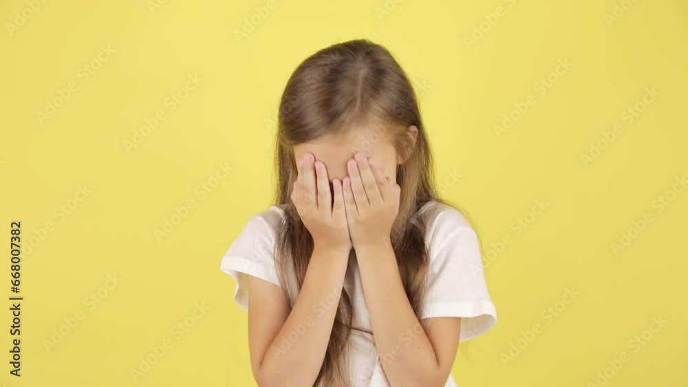 Kids problems. Studio portrait of upset child girl crying and wiping ...