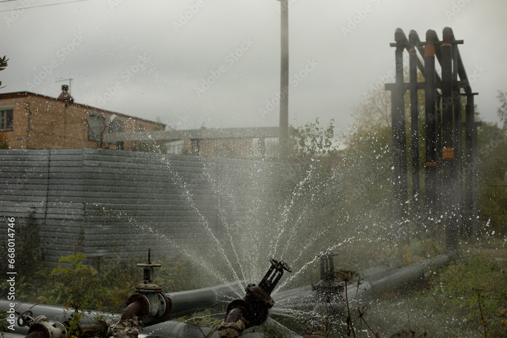 Pipeline accident. Boiling water pours from pipe. Boiler room emergency ...