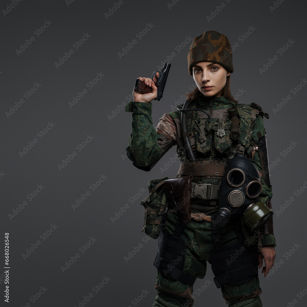 Portrait of a female soldier in military uniform and cap, with a ...
