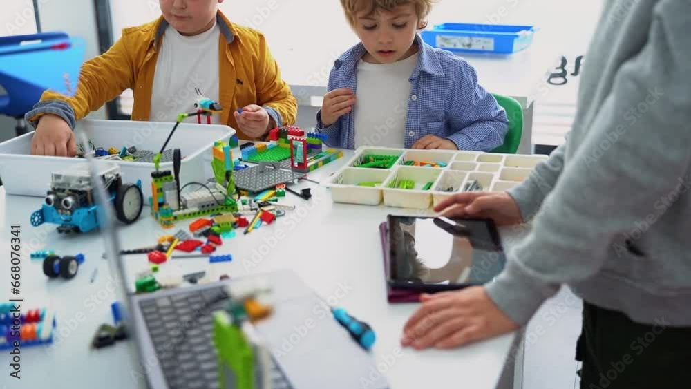 Robotics programming class. Children construct and code Robot. STEM ...