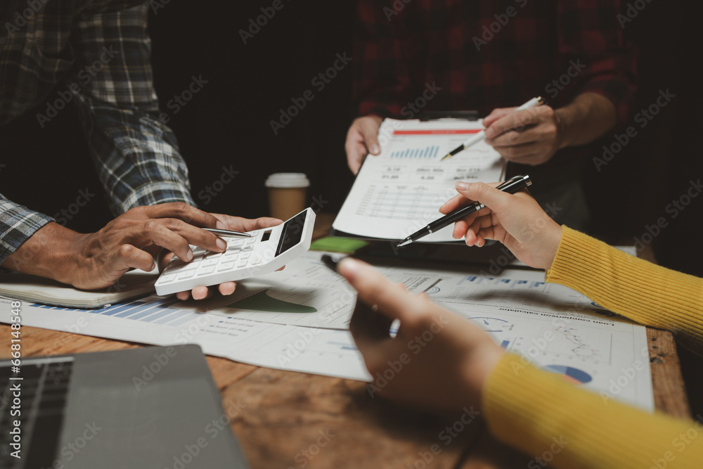 Group of businessmen working together to calculate income, They are ...