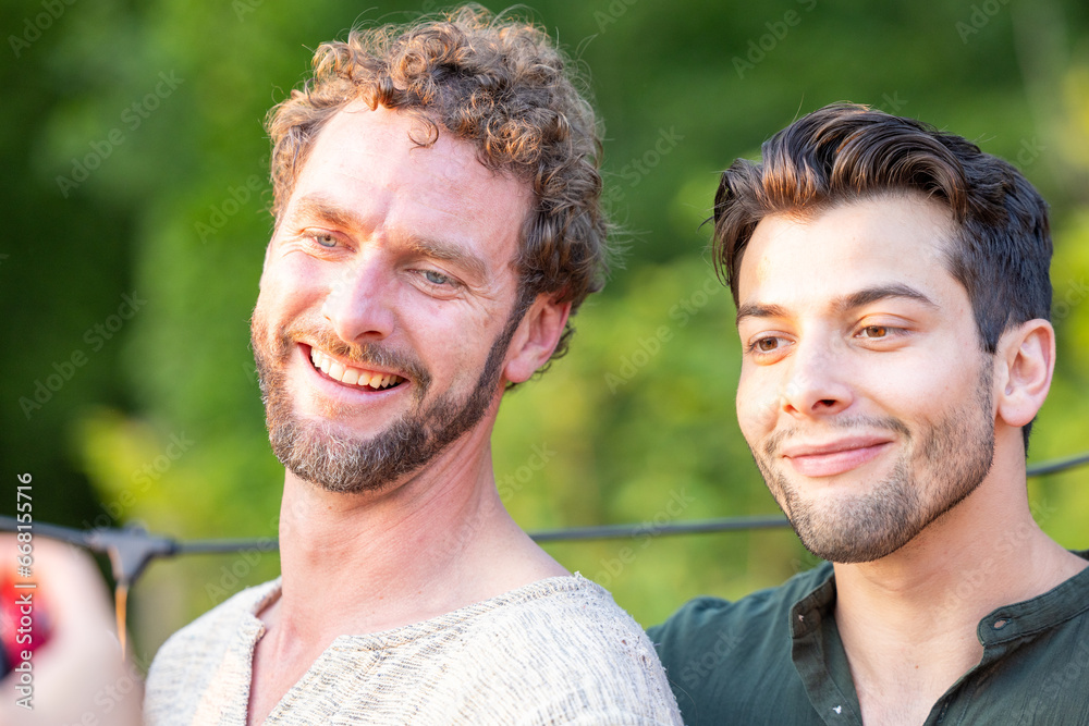 Two attractive young millennial men, one Caucasian and one with a ...