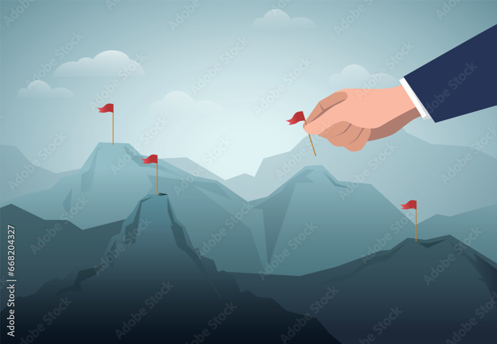 Human hand inserting a flag into top of mountain.Task completion ...